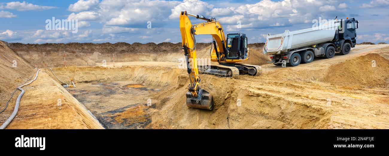 excavator is working and digging at construction site Stock Photo - Alamy