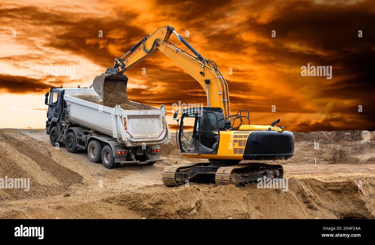 excavator is working and digging at construction site Stock Photo - Alamy