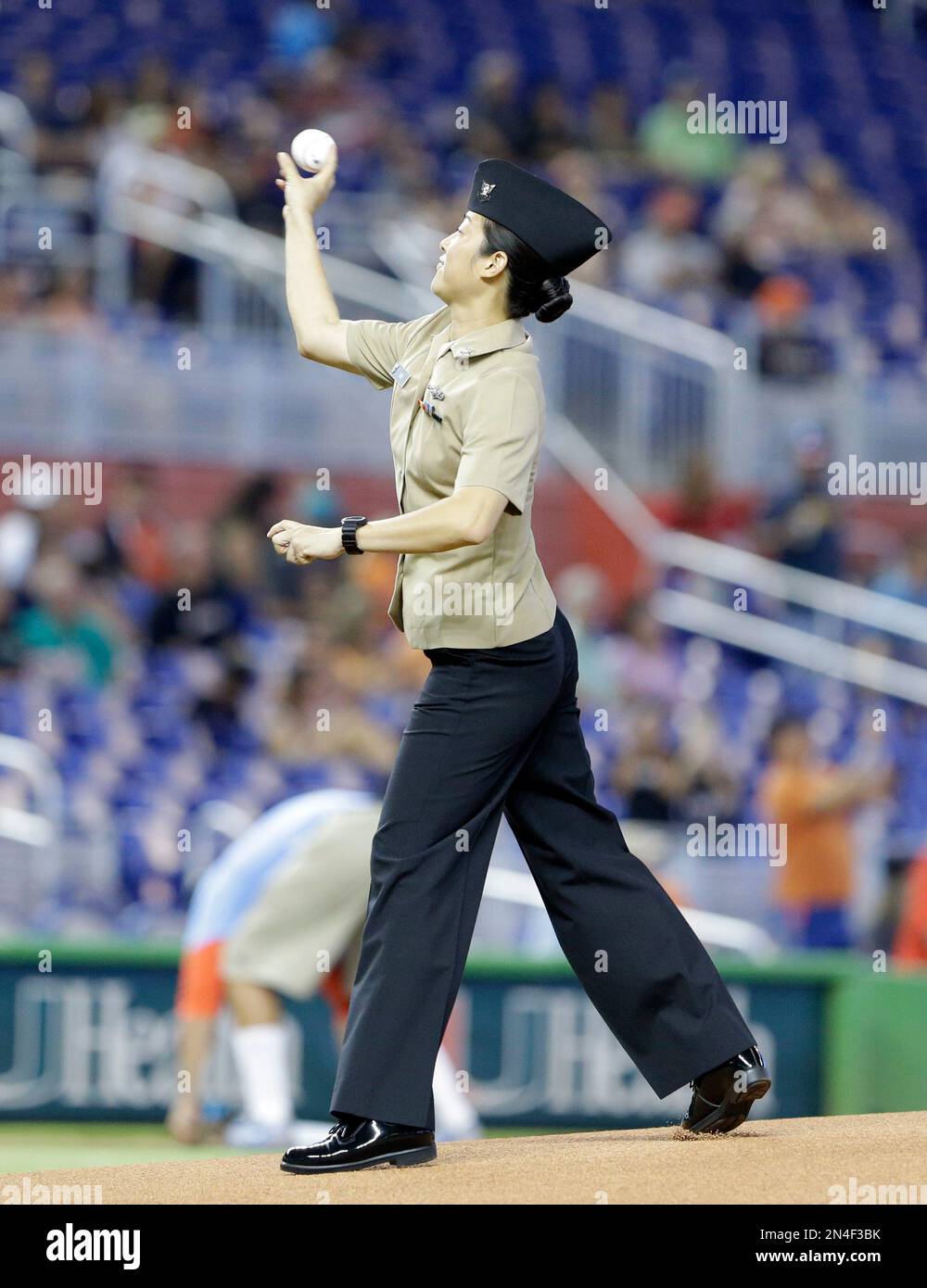 U.S. Navy Petty Officer 2nd class Lori Kim throws out a ceremonial ...