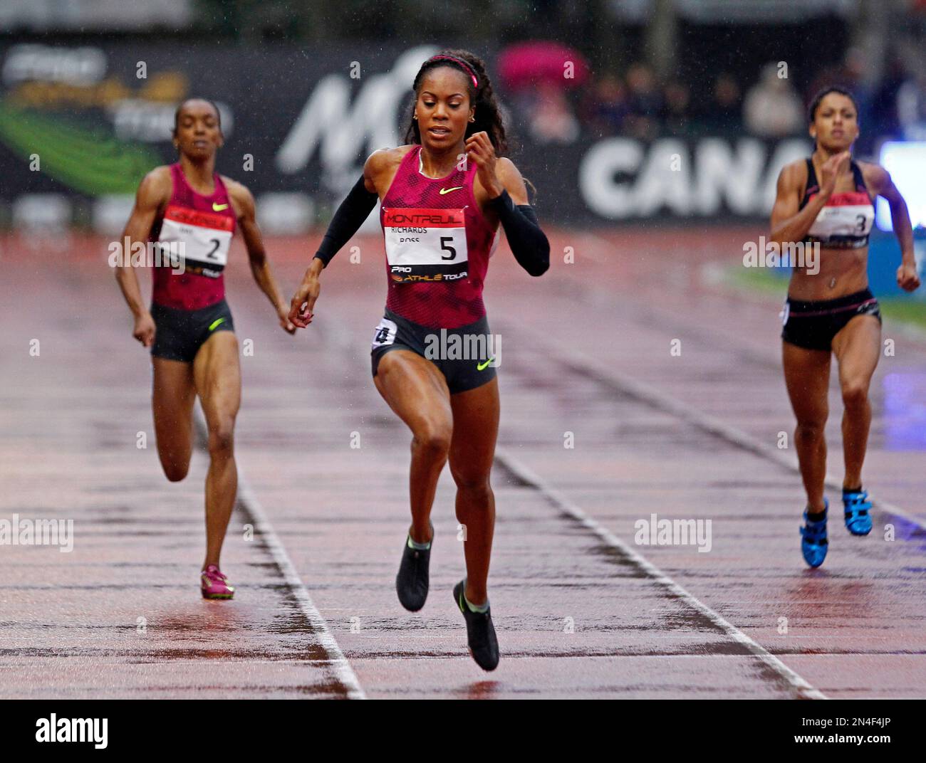U.S. Sanya Richards-Ross, center, crosses the finish line to win the ...