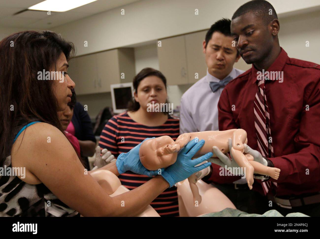 In this June 25, 2014 photo, interns gather around during an intern ...