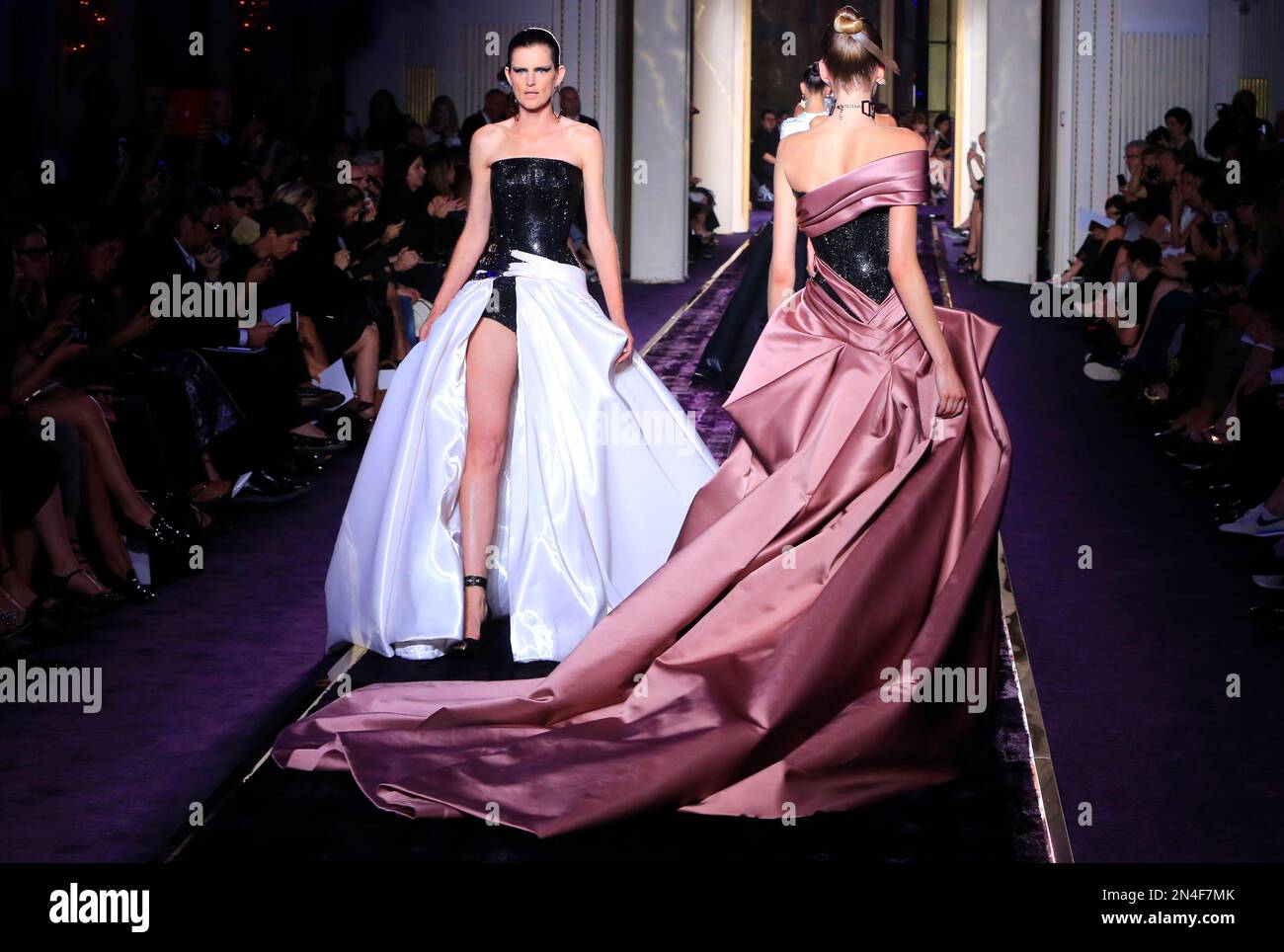 Models present creations by Italian fashion designer Donatella Versace ...