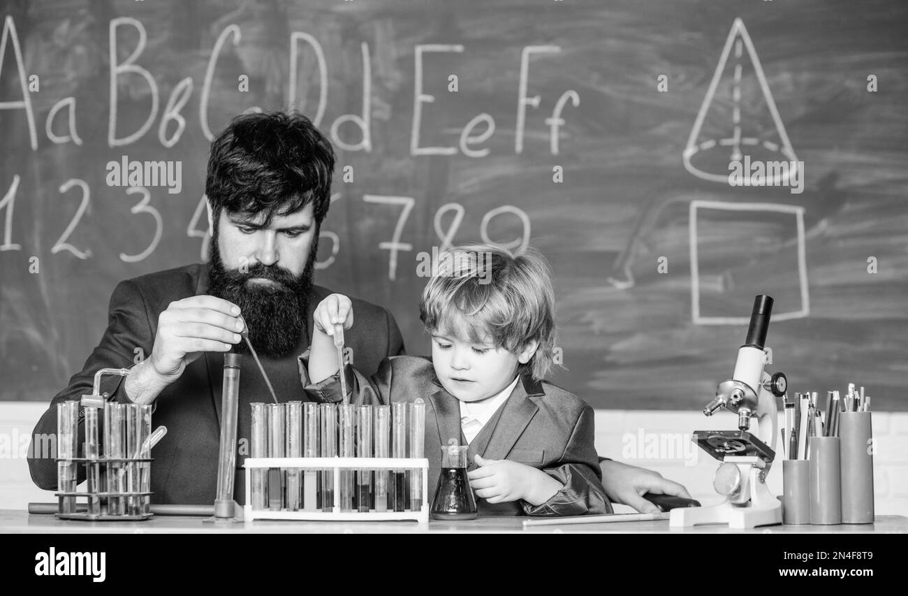father and son at school. teacher man with little boy. Back to school ...