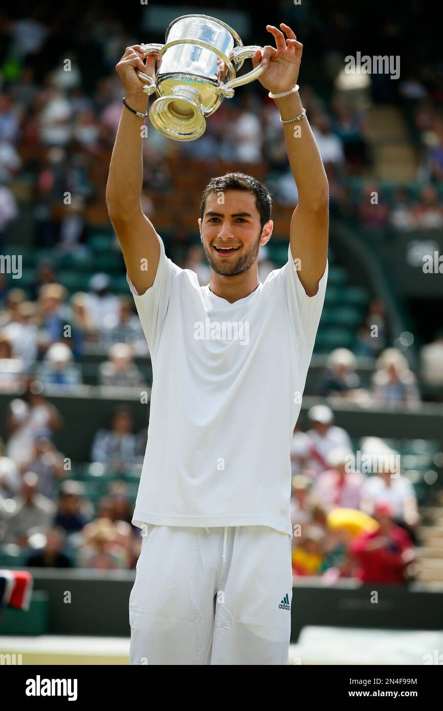 Noah Rubin of the U.S holds up the trophy after defeating Stefan Kozlov of the U.S in the boys ...