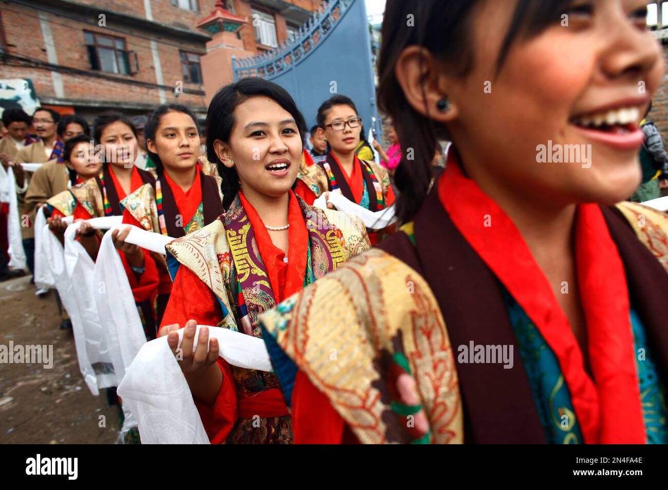 Tibetan girls sing a song during celebrations to mark the birthday of ...