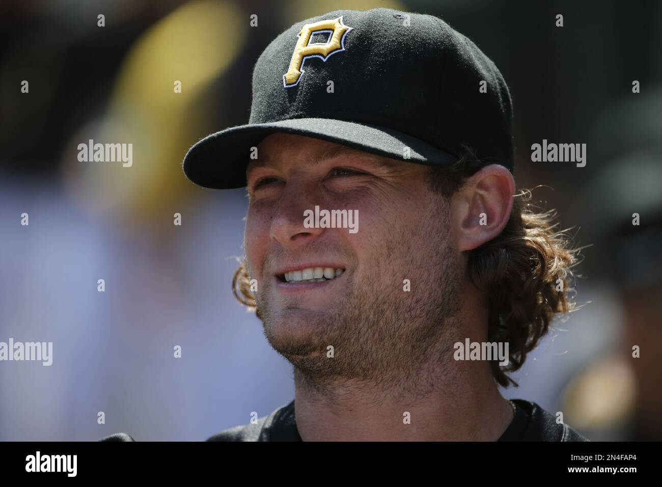 Pittsburgh Pirates' Gerrit Cole stands in the dugout before a baseball ...