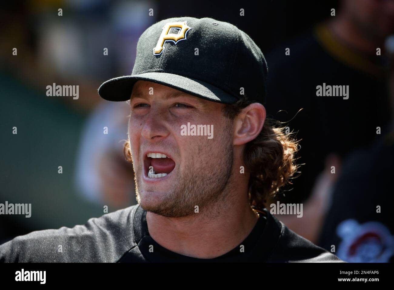 Pittsburgh Pirates' Gerrit Cole stands in the dugout before a baseball ...