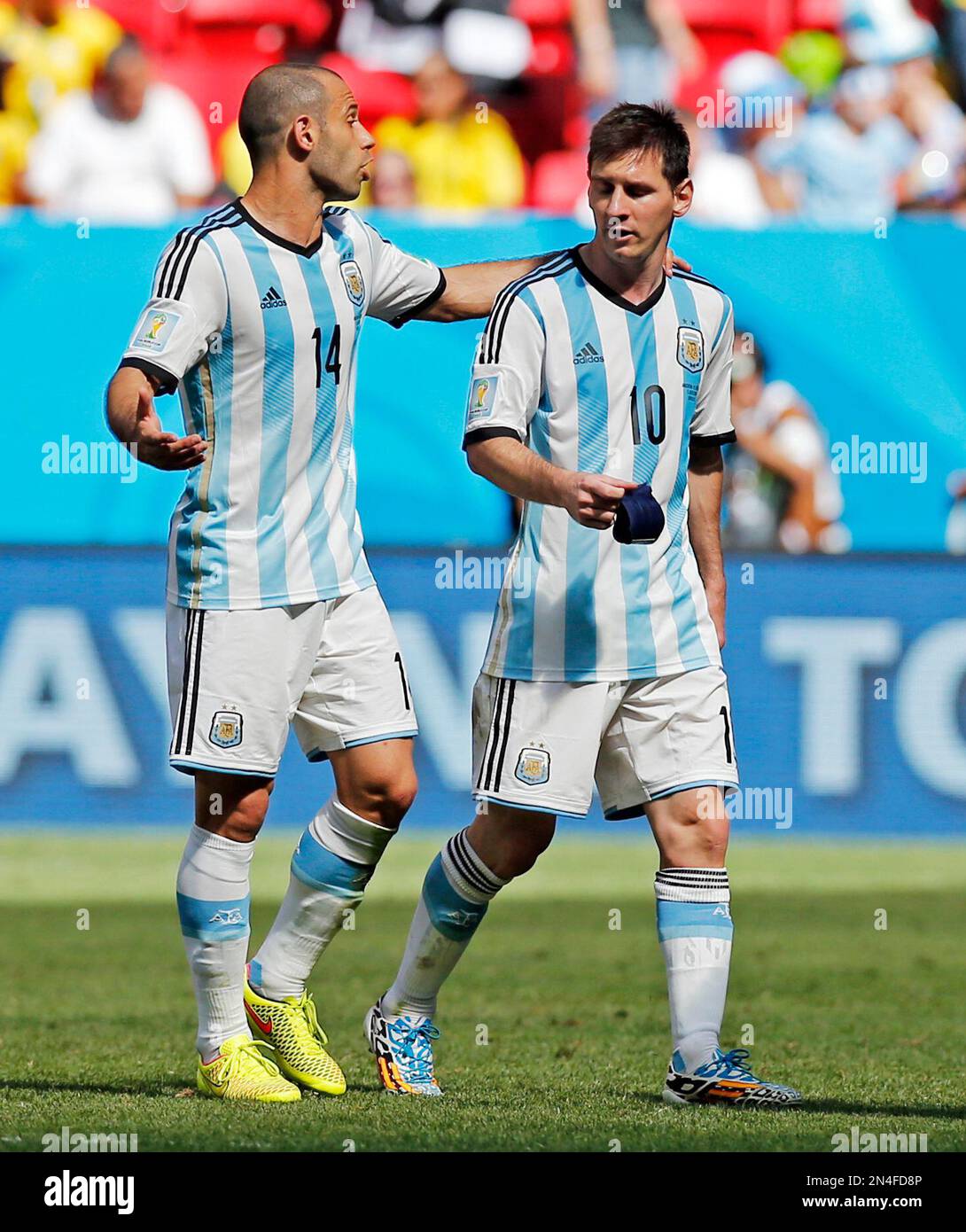 Argentina's Lionel Messi, right, talks to his teammate Javier ...