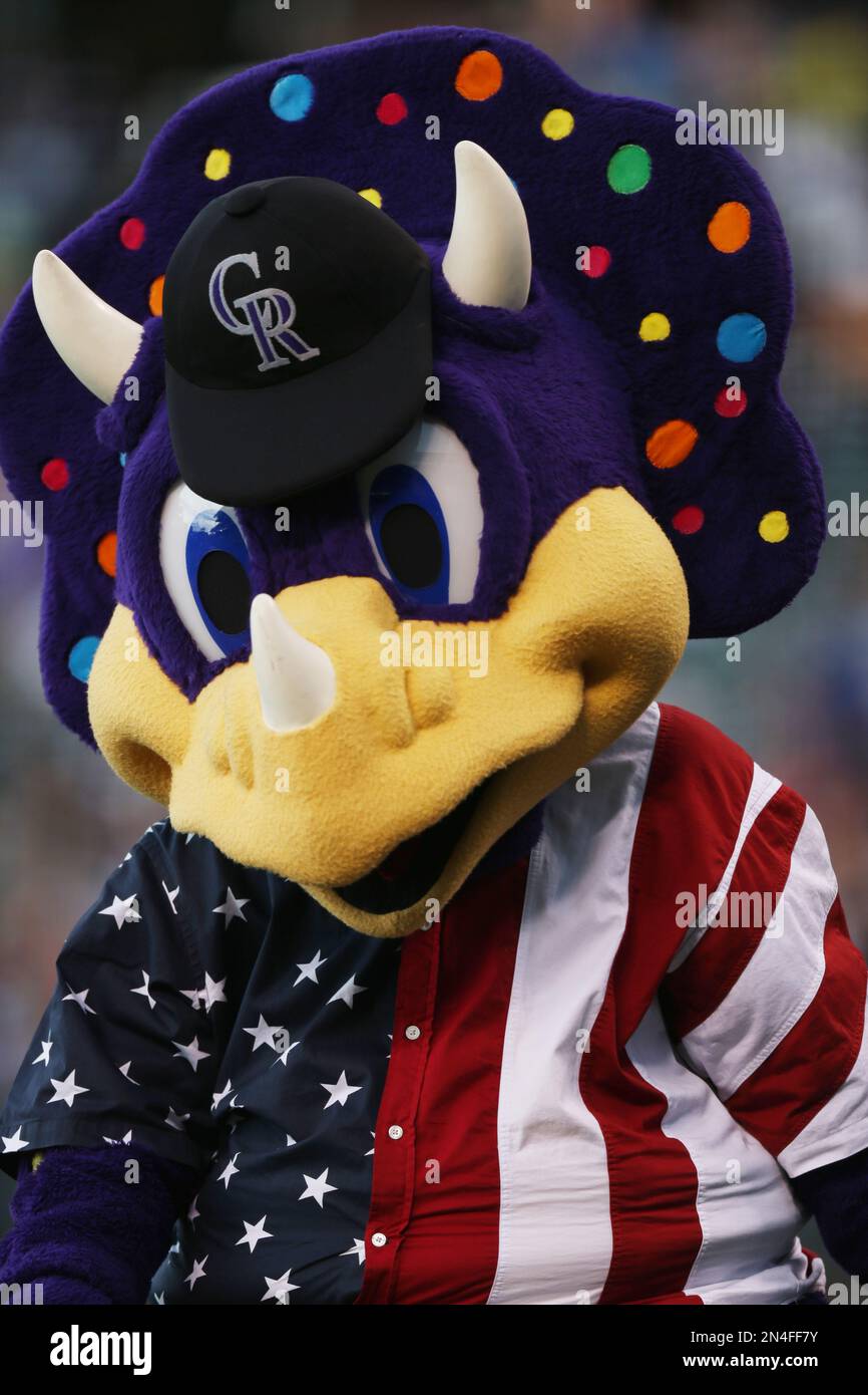 Dinger the dinosaur, the mascot of the Colorado Rockies, wears a shirt ...