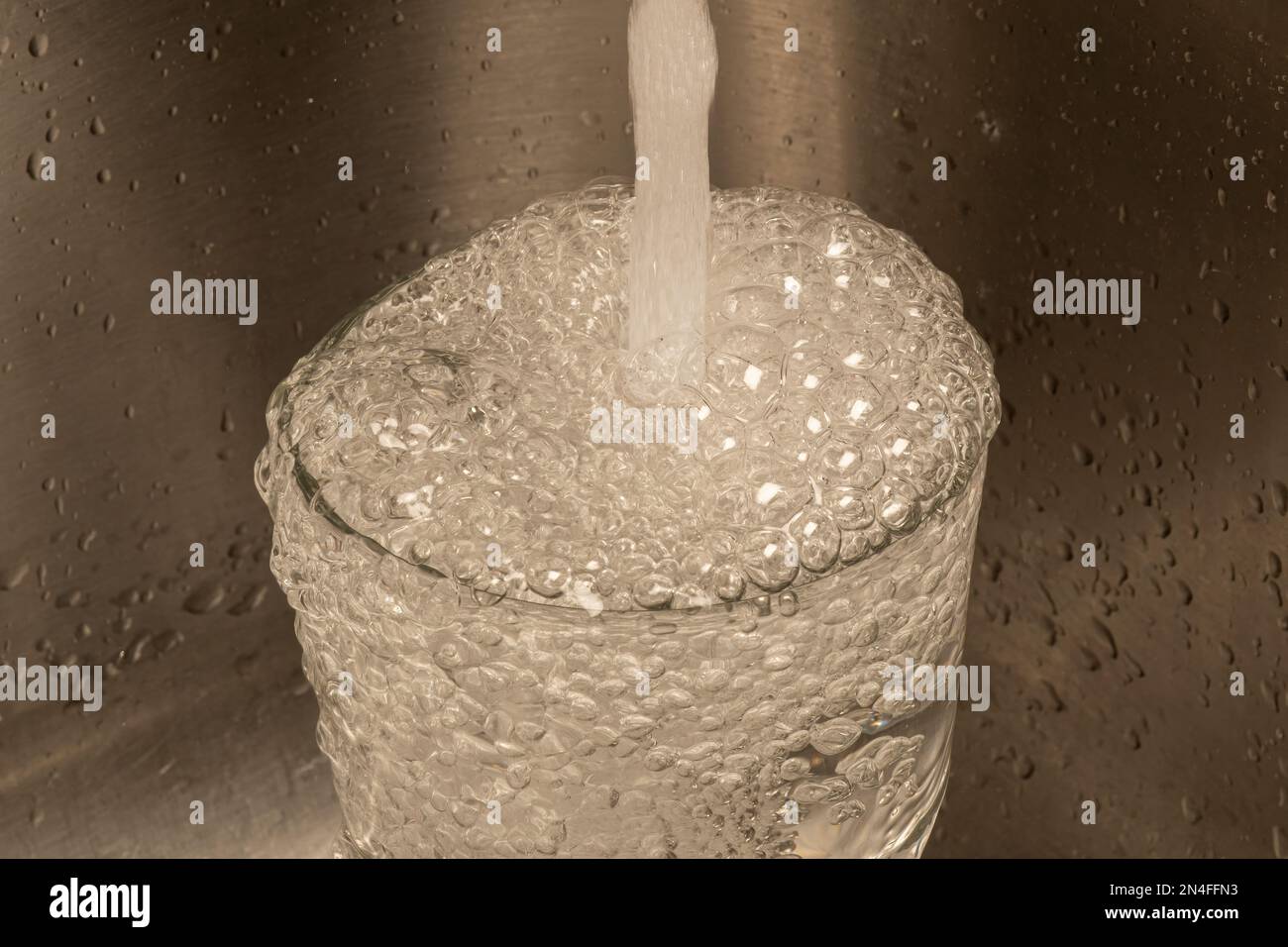 Close-up photo of water overflowing a drinking glass Stock Photo - Alamy