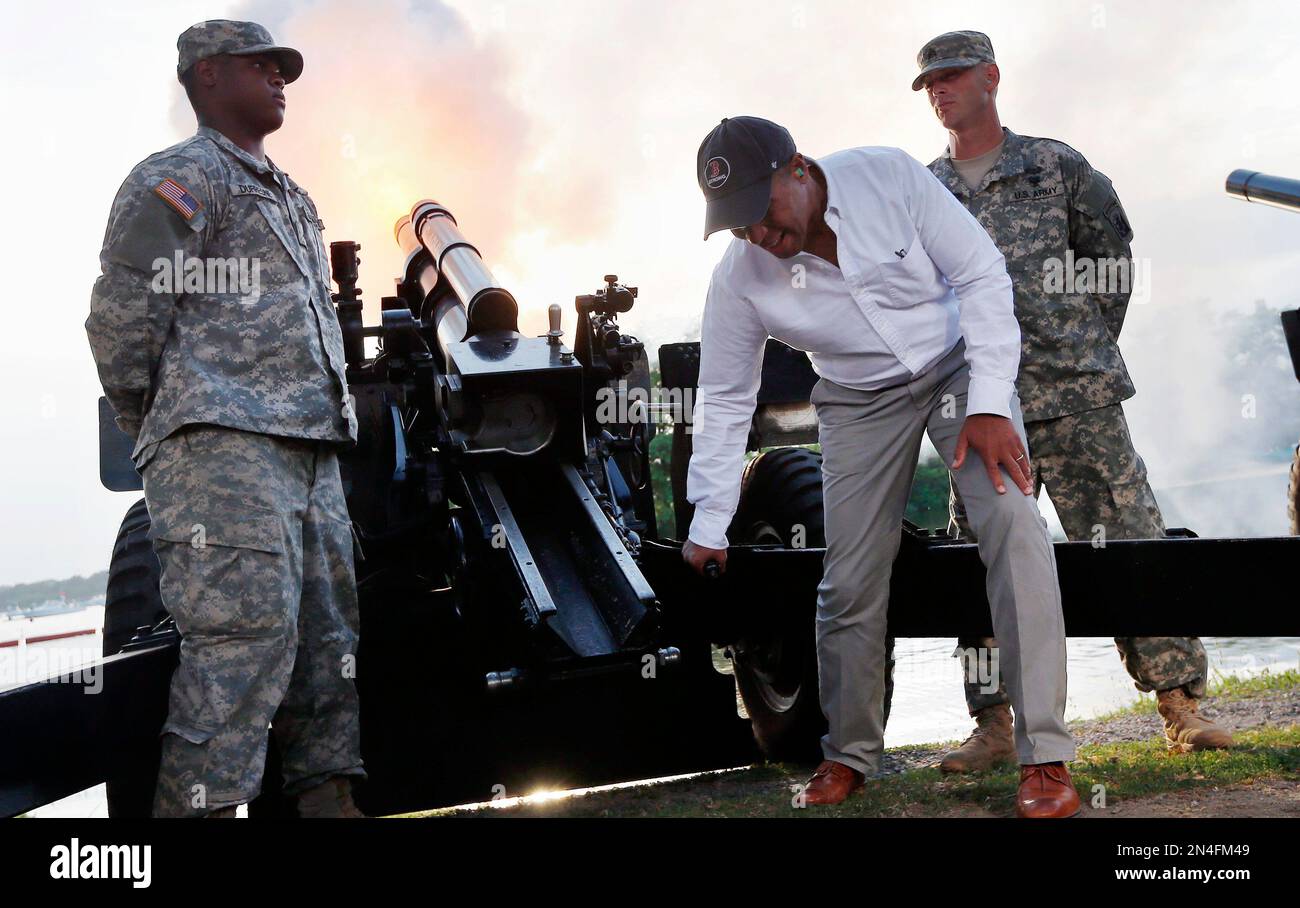 Massachusetts Gov. Deval Patrick, center, test-fires a howitzer before ...