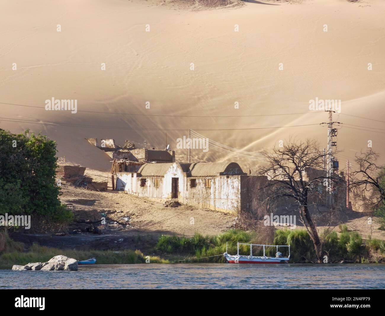 An old destroyed house buried in the desert in the dunes of Egypt by a ...
