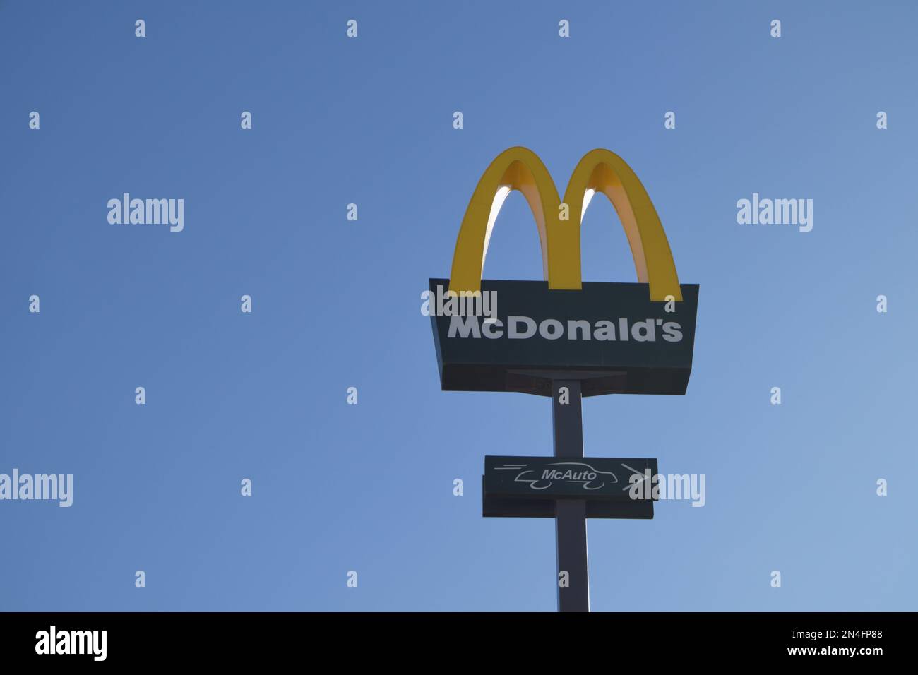 Tall pylon with the logo of the American fast food franchise Mcdonals ...