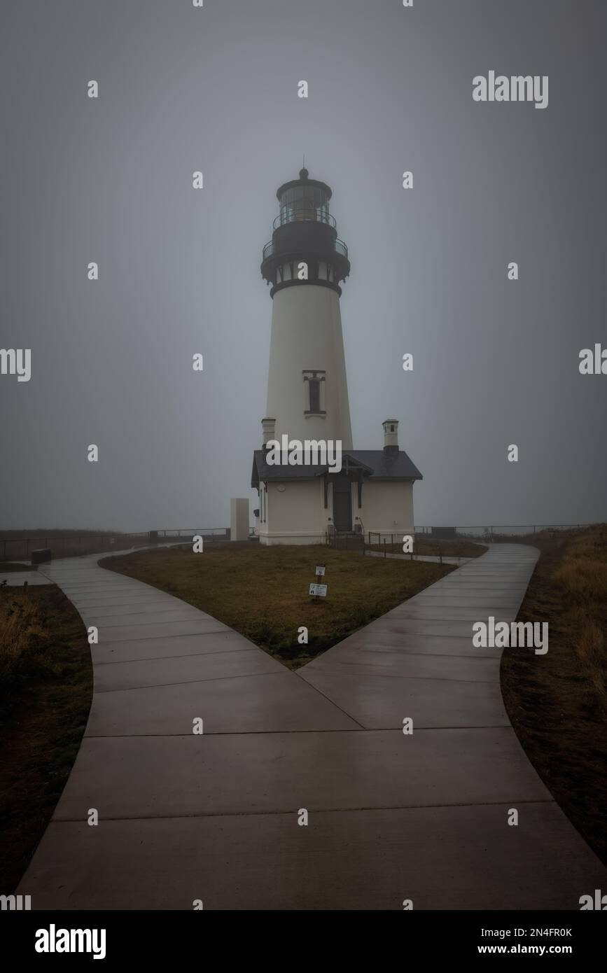 A vertical shot of the Yaquina Head Lighthouse on foggy rainy day Stock ...