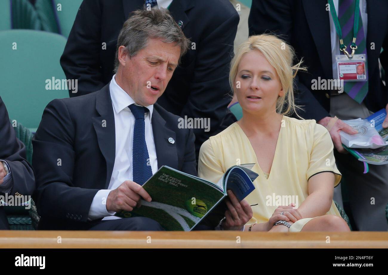 British actor Hugh Grant, left, looks at a program with Kitty McIntyre ...