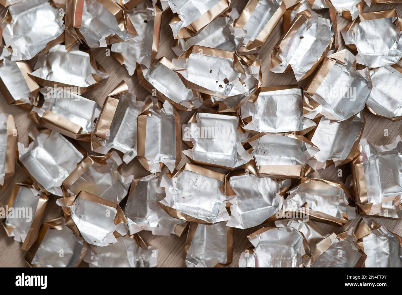 Pile of empty silver-gold candy wrappers. Top view Stock Photo - Alamy