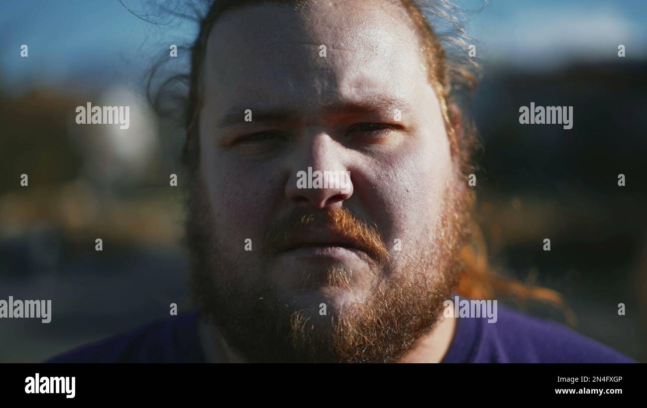 Portrait of an upset casual man close up face looking at camera. One ...