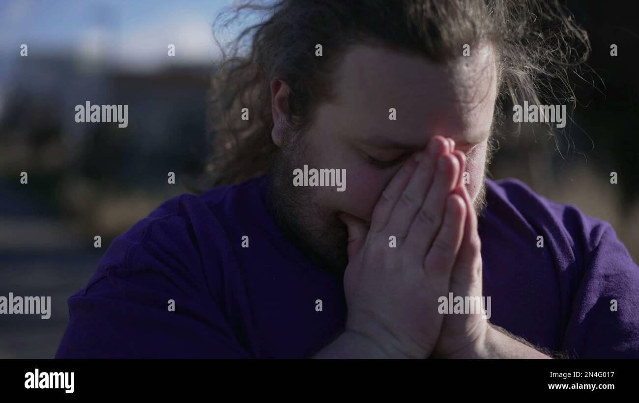 One young man praying to God during hard times. Faithful person in ...