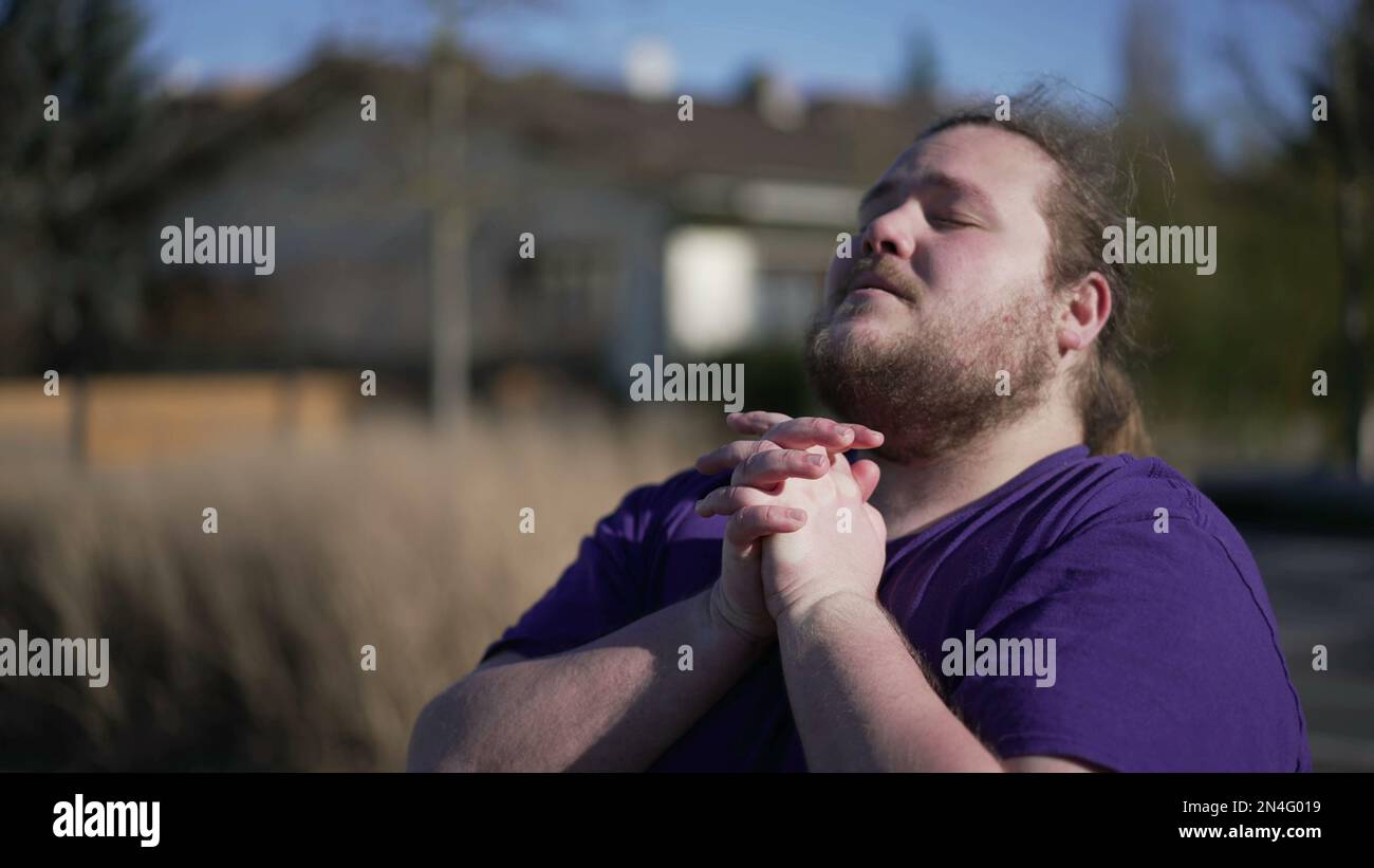 One young man praying to God during hard times. Faithful person in ...