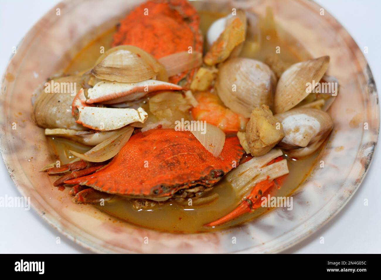 Hot soup meal of various fresh seafood marine crabs, shrimps, clams ...