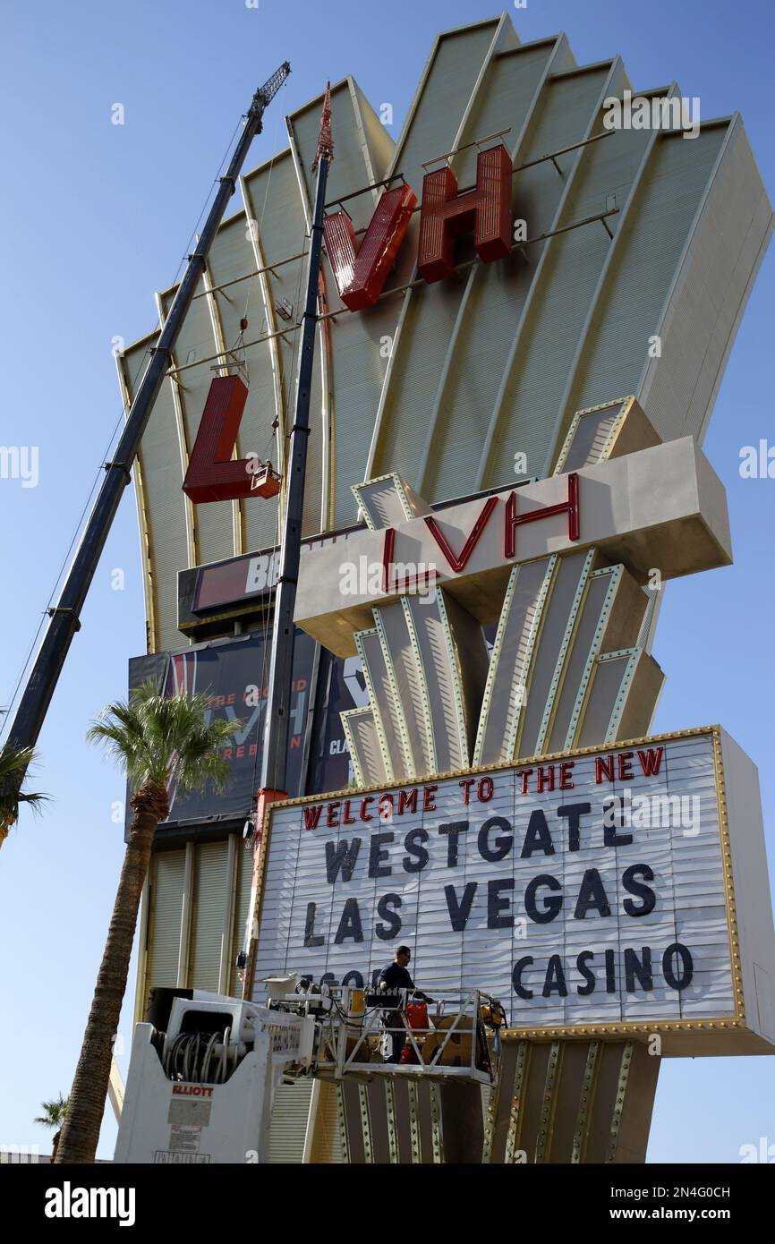Construction workers lower part of the LVH sign Tuesday, July 1, 2014 ...