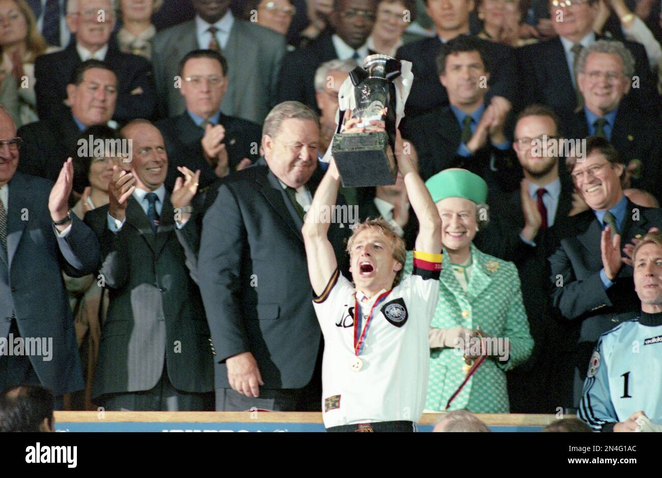 German soccer team captain Jurgen Klinsmann raises the European ...