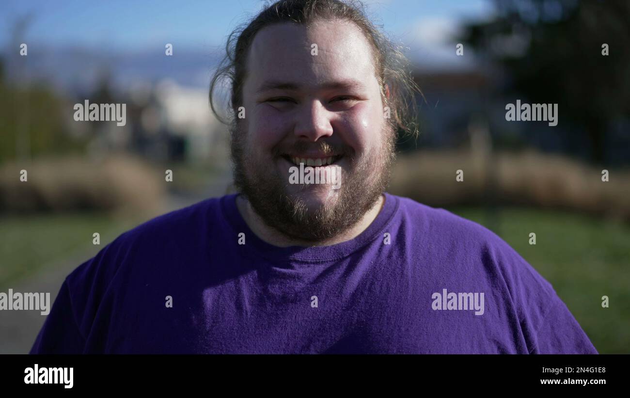 One happy overweight man walking forward outdoors smiling. A joyful fat ...
