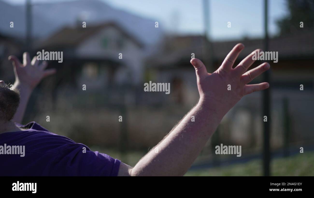 One happy young man raising arms in the air celebrating success ...