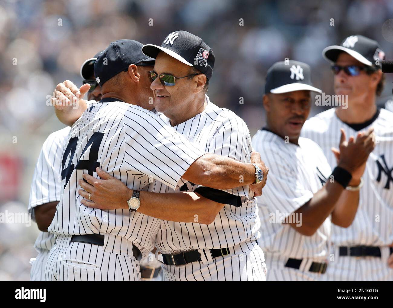 Hall of Famer Reggie Jackson (44) embraces former New York Yankees Joe ...