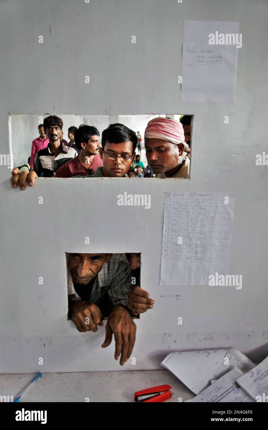 Hindu devotees stand in a queue outside the registration counter for the annual pilgrimage to ...