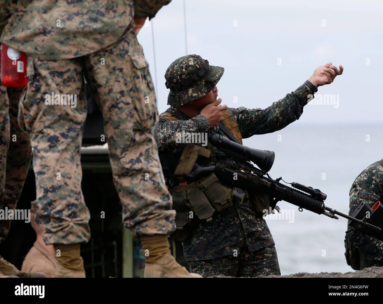 A Philippine Marine takes aim at an imaginary aircraft following the ...
