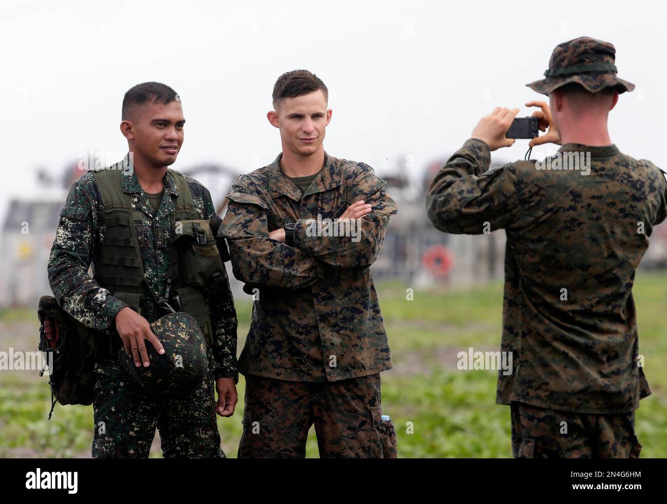 A U.S. Marine and his Philippine counterpart have their pictures taken ...