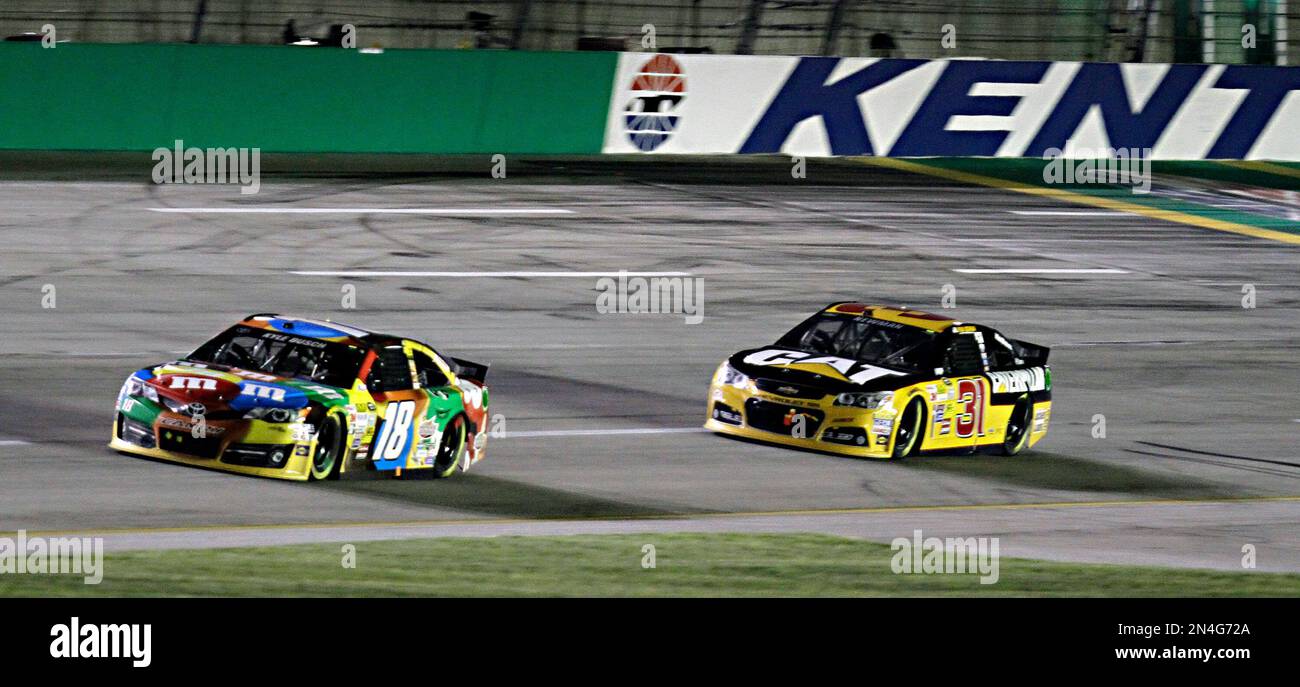 Driver Kyle Busch (18) stays in front of Ryan Newman (31) heading into ...