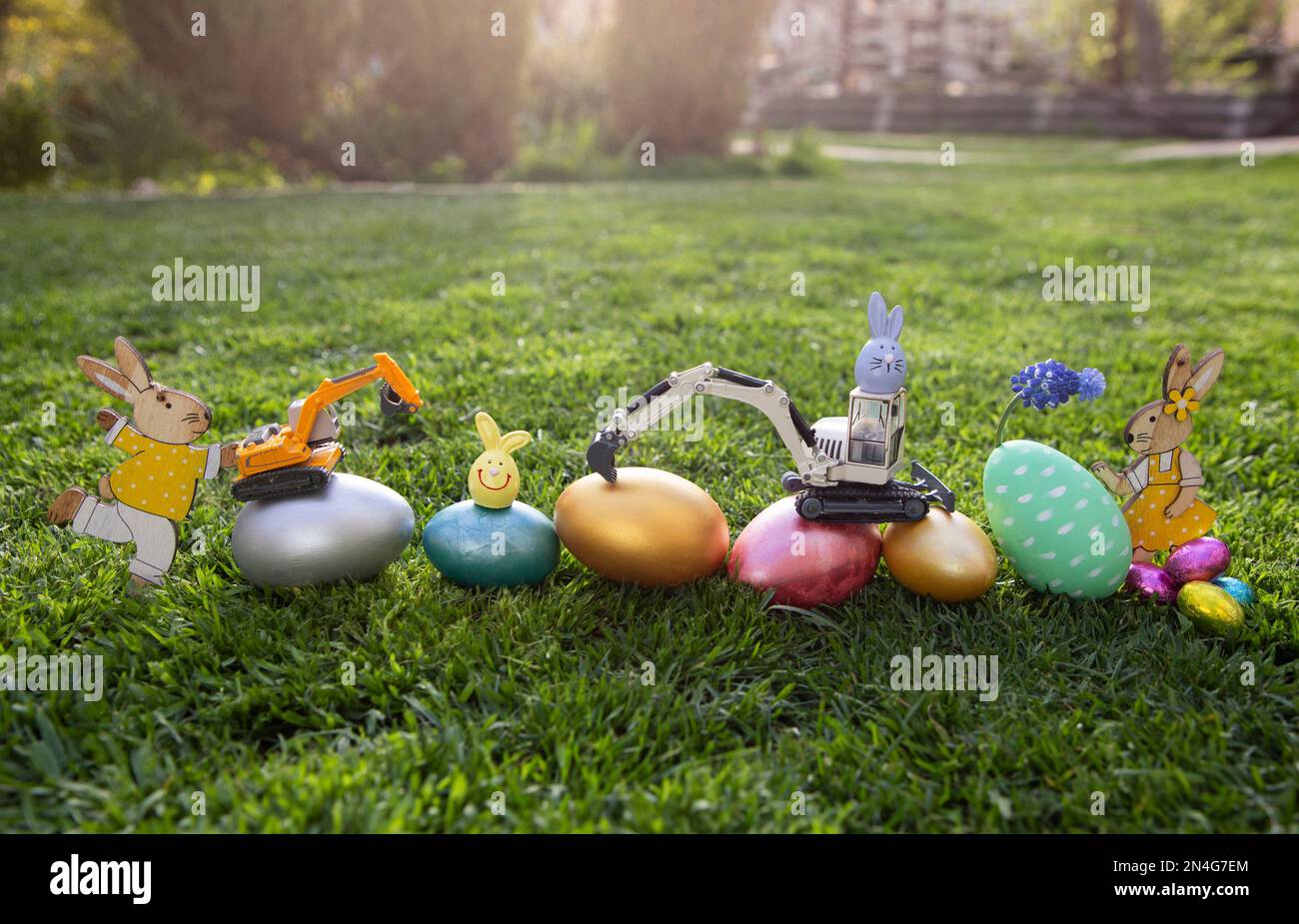 Easter spring festive composition of 2 models of toy excavators ...