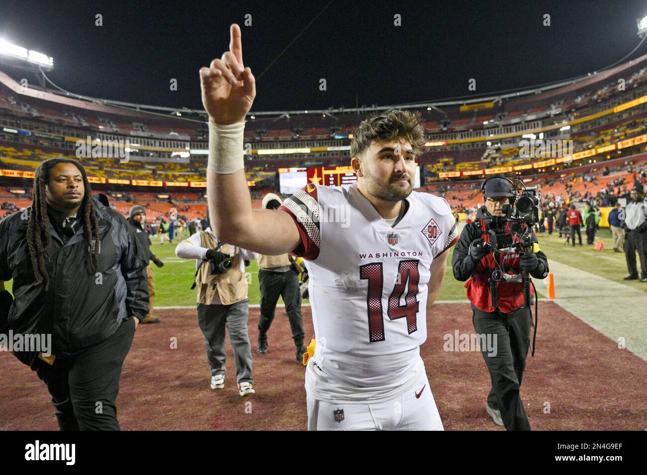 FILE - Washington Commanders quarterback Sam Howell (14) gestures as he leaves the field after ...