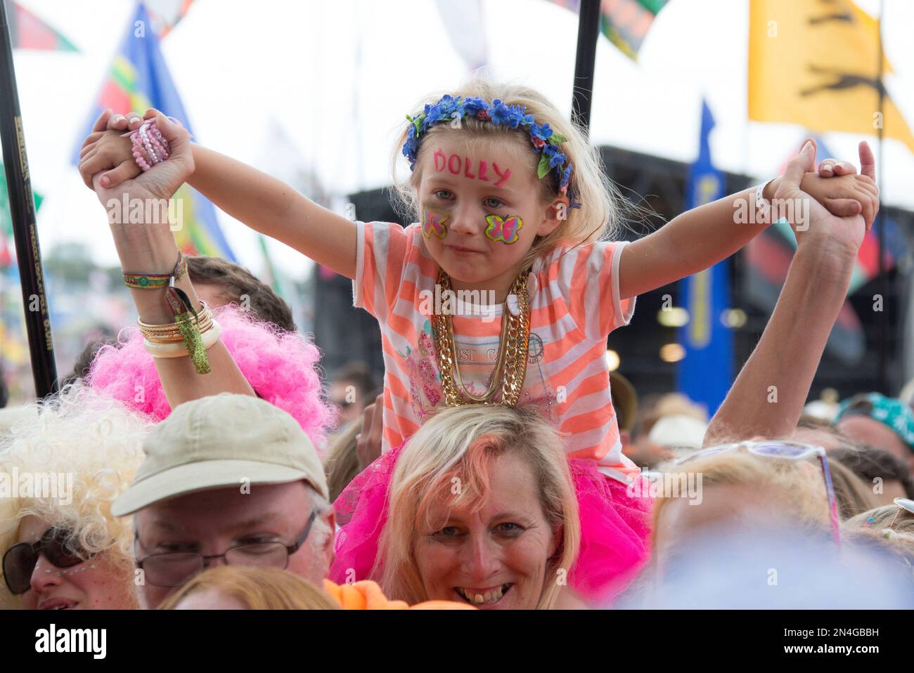 A young Dolly Parton fan awaits her performance on the main Pyramid ...