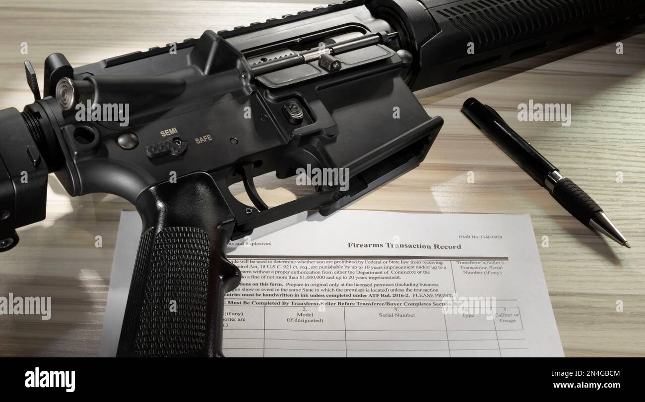 Public domain form 4473 and AR-15 with pen nearby Stock Photo - Alamy