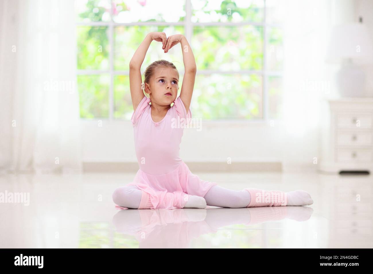 Baby ballet studio. Little ballerina in dance class. Cute girl in pink ...