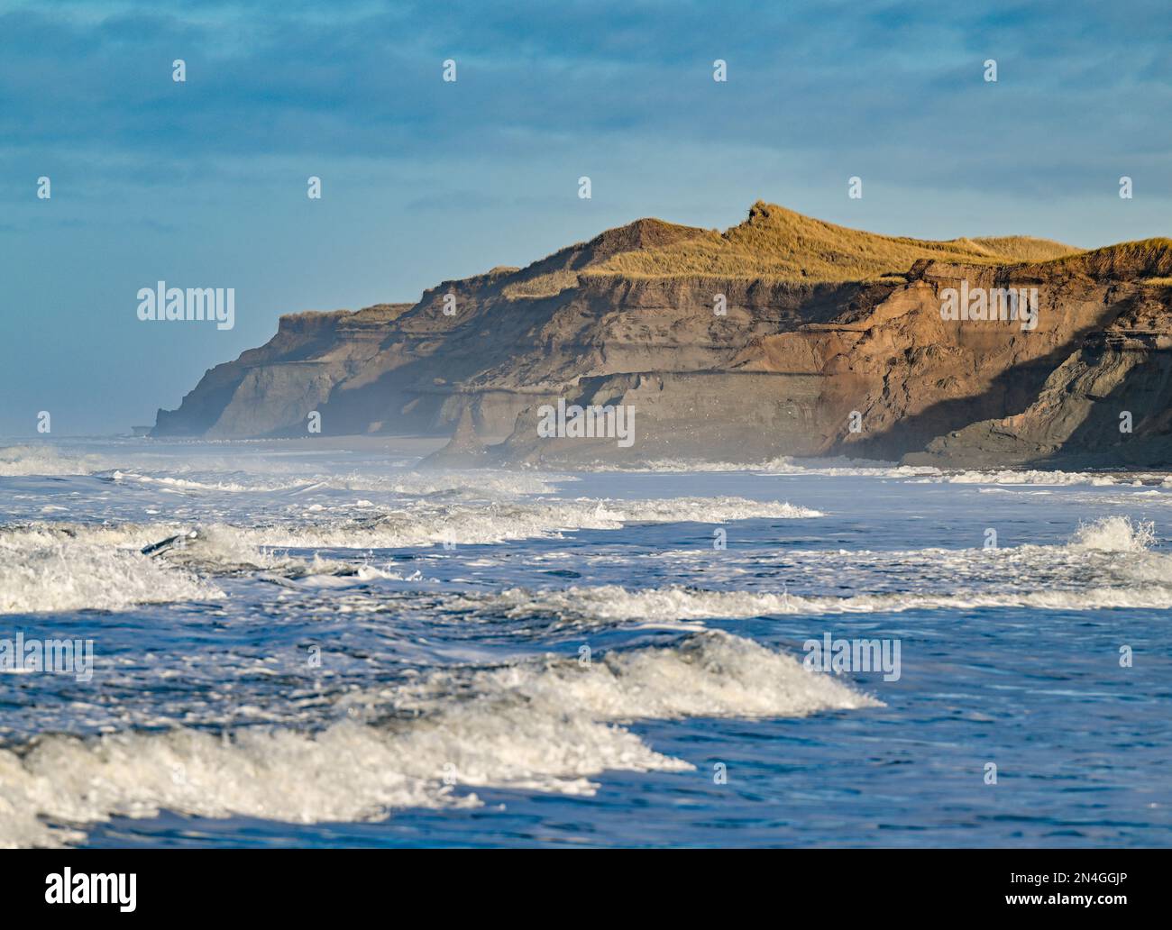 Agger, Denmark. 02nd Feb, 2023. In the light of the morning sun waves ...