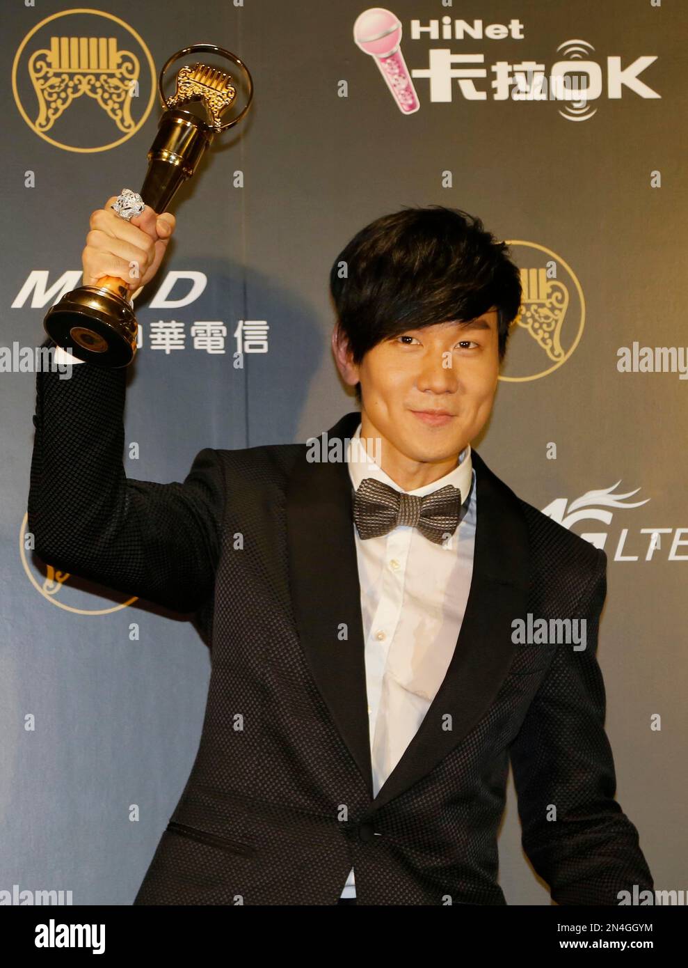 Singapore singer JJ Lin holdss his award and jumps after winning the ...