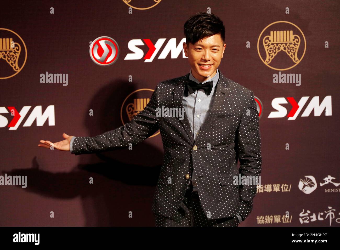 Taiwanese singer William Wei poses for photographers as he arrives at ...
