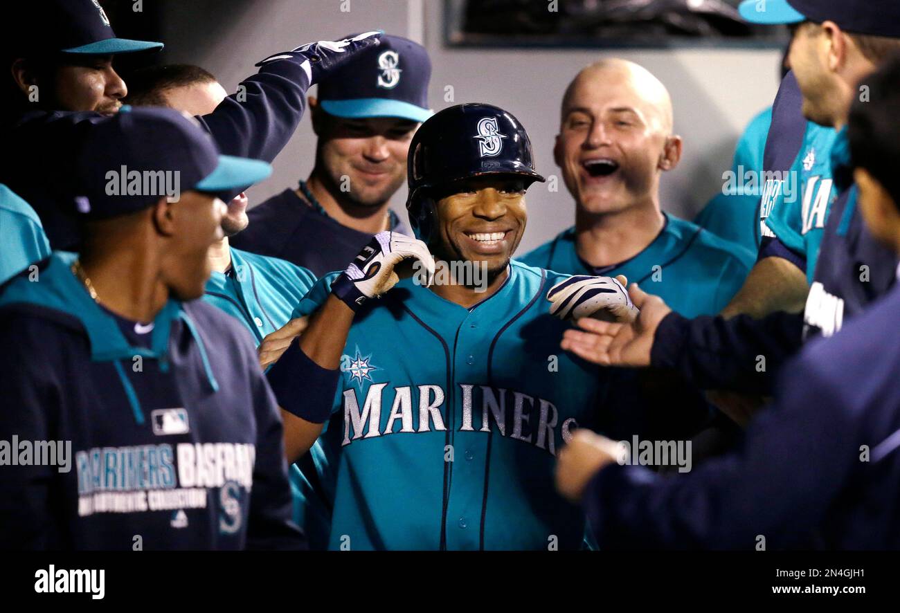Seattle Mariners' Endy Chavez, center, is congratulated in the dugout ...