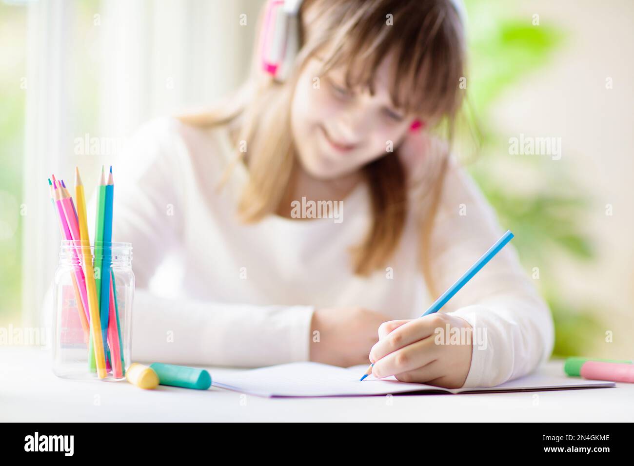 Teenage girl writing or drawing in notebook. Online art class. School ...