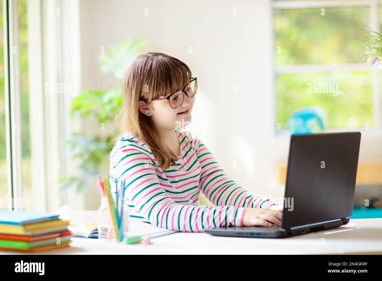 Teenage girl writing or drawing in notebook. Online art class. School child doing homework. Arts ...