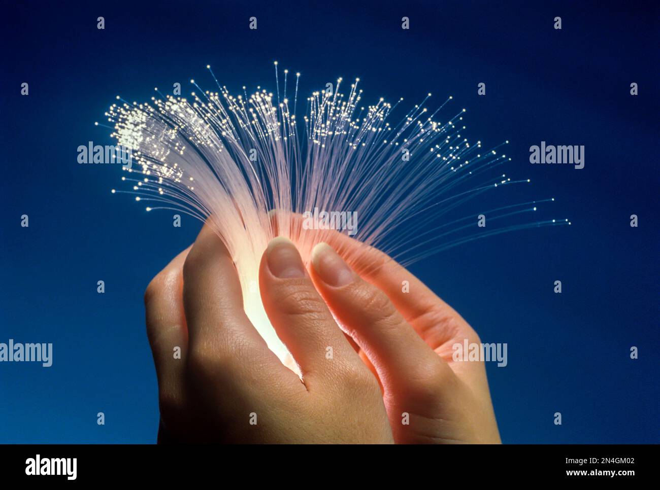 WOMANS HANDS HOLDING FIBER OPTIC STRANDS (©KECK MAURER & SCHULTZ ...