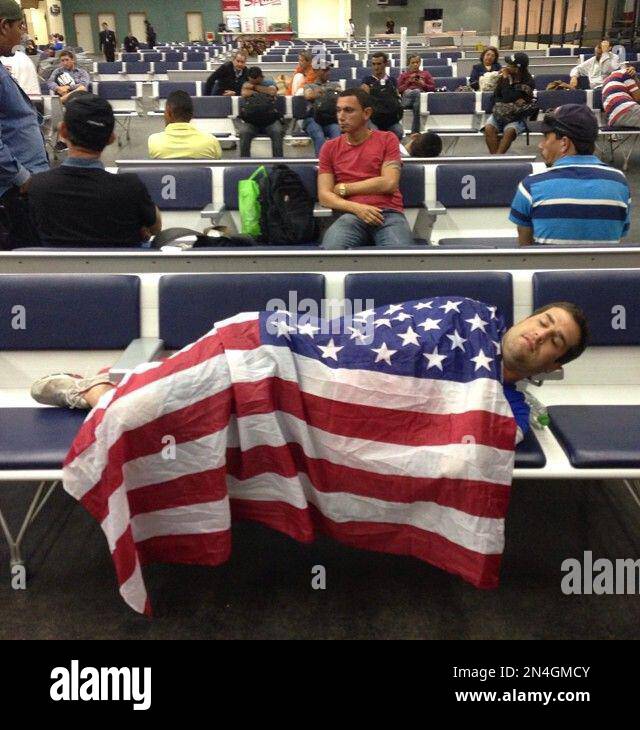 Derek Stephenson of Washington naps at Manaus airport the morning after ...