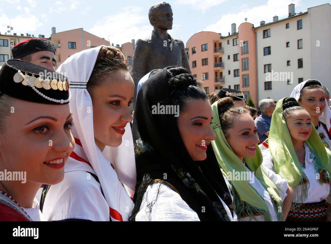 Bosnian folk dancers posing in front of statue during ceremony of ...