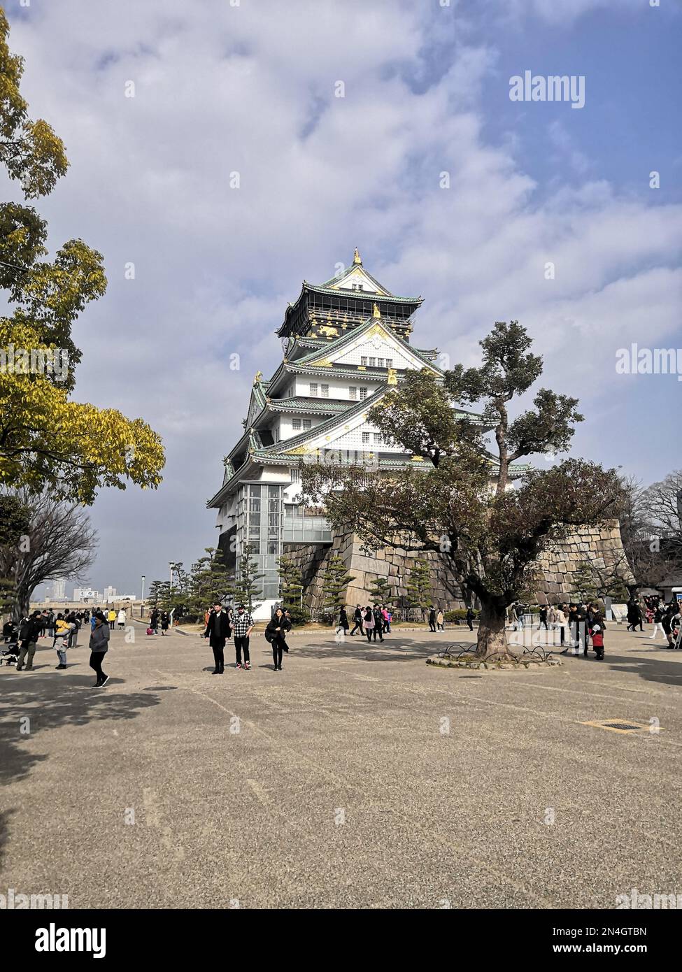A vertical shot of visitors at Osaka Castle Tourist destination in ...