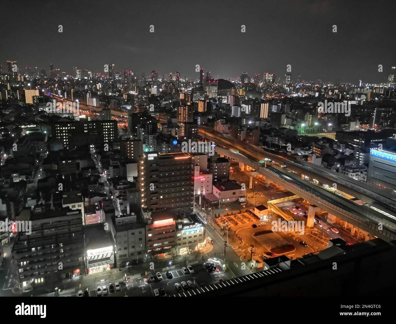An aerial view of the illuminated Osaka skyline at night Stock Photo ...