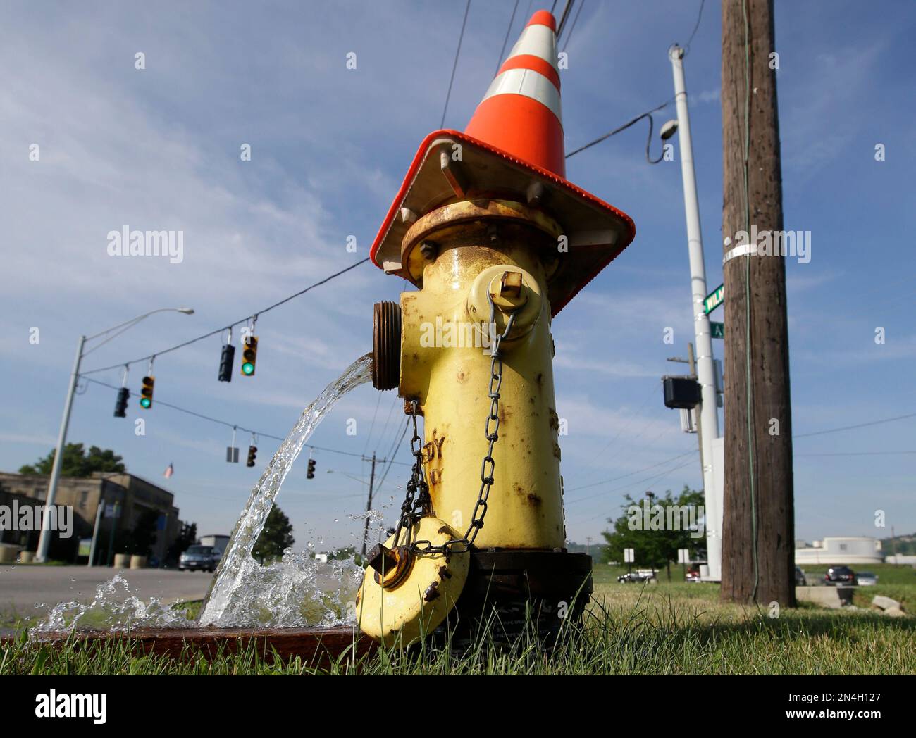 A road pylon caps the top of a fire hydrant being serviced, Thursday ...